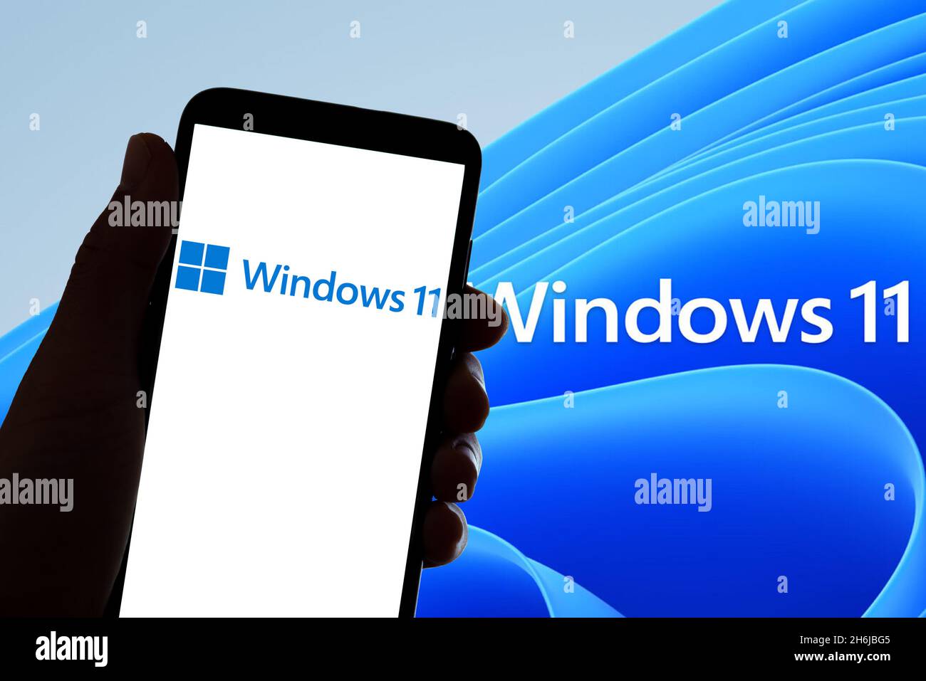 The new Microsoft Os Windows 11 logo is seen on the screen of a mobile ...