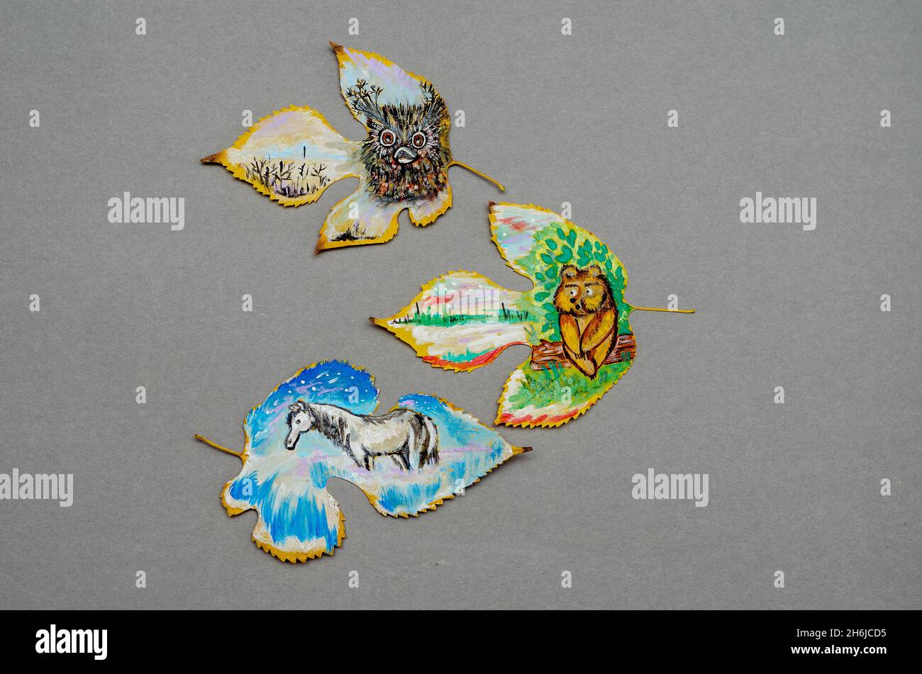 Fallen tree leaves with animals drawn on them. Funny drawings of a bear ...