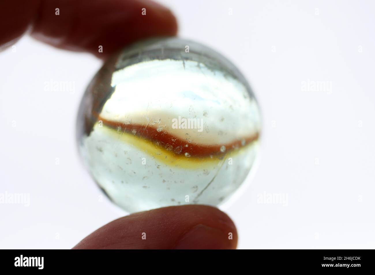 Toys. holding the glass ball Stock Photo - Alamy