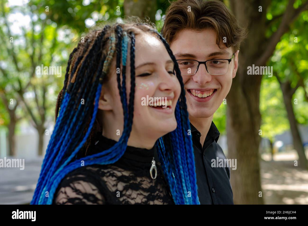 Happy young family. A woman with long blue dreadlocks and a man with ...