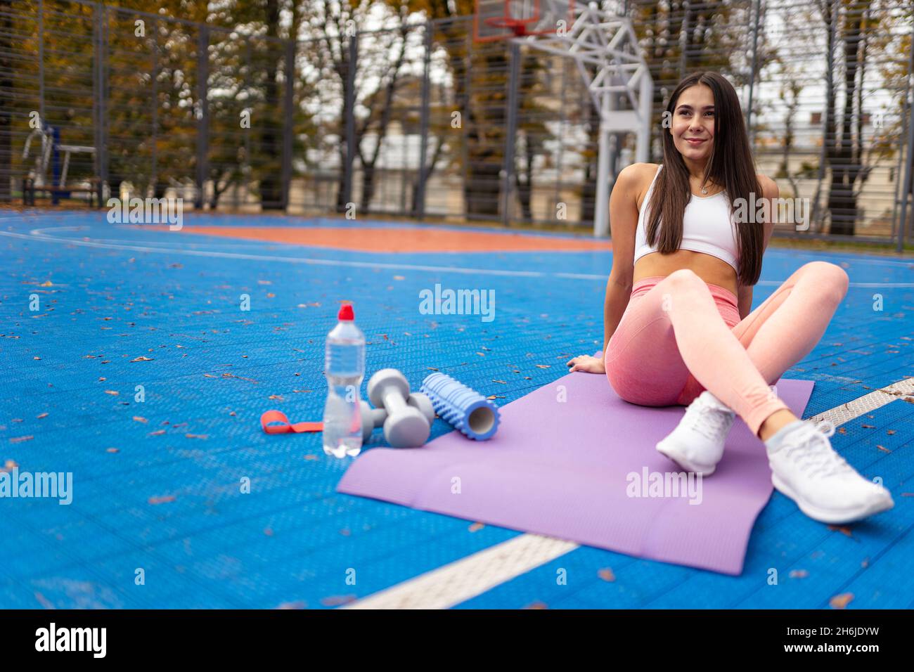 Sporty girl resting on fitness rug Stock Photo - Alamy