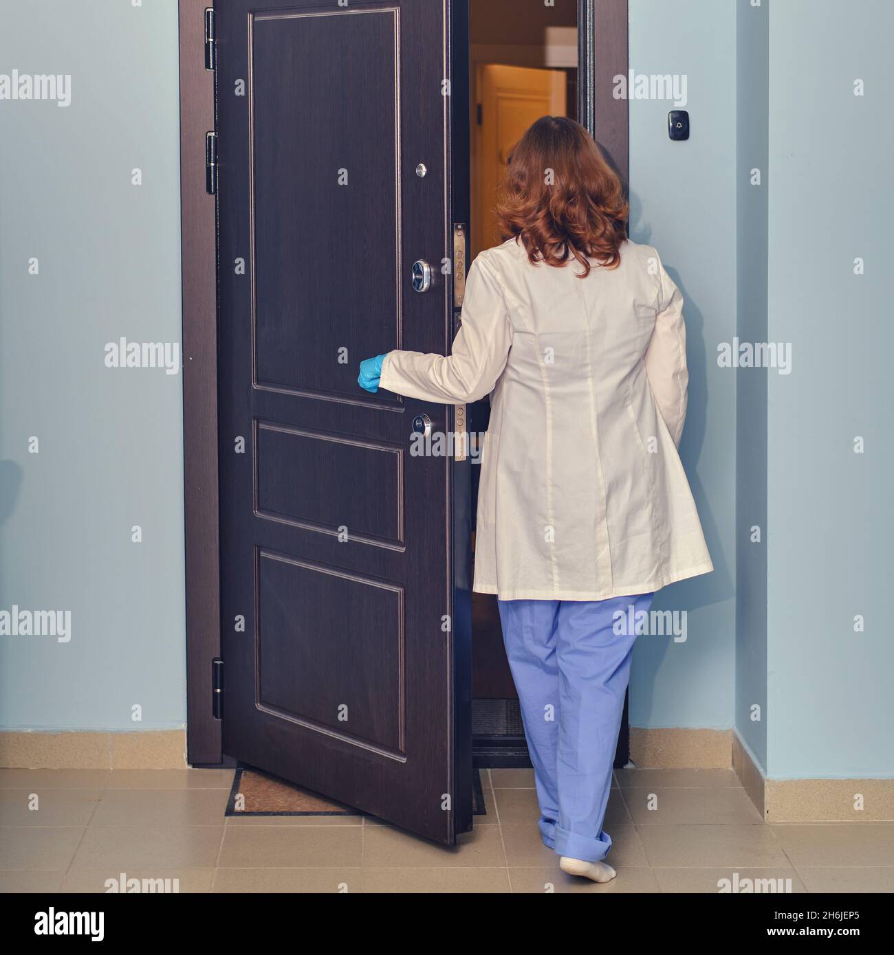 Woman doctor enters the apartment when visiting a patient home Stock ...