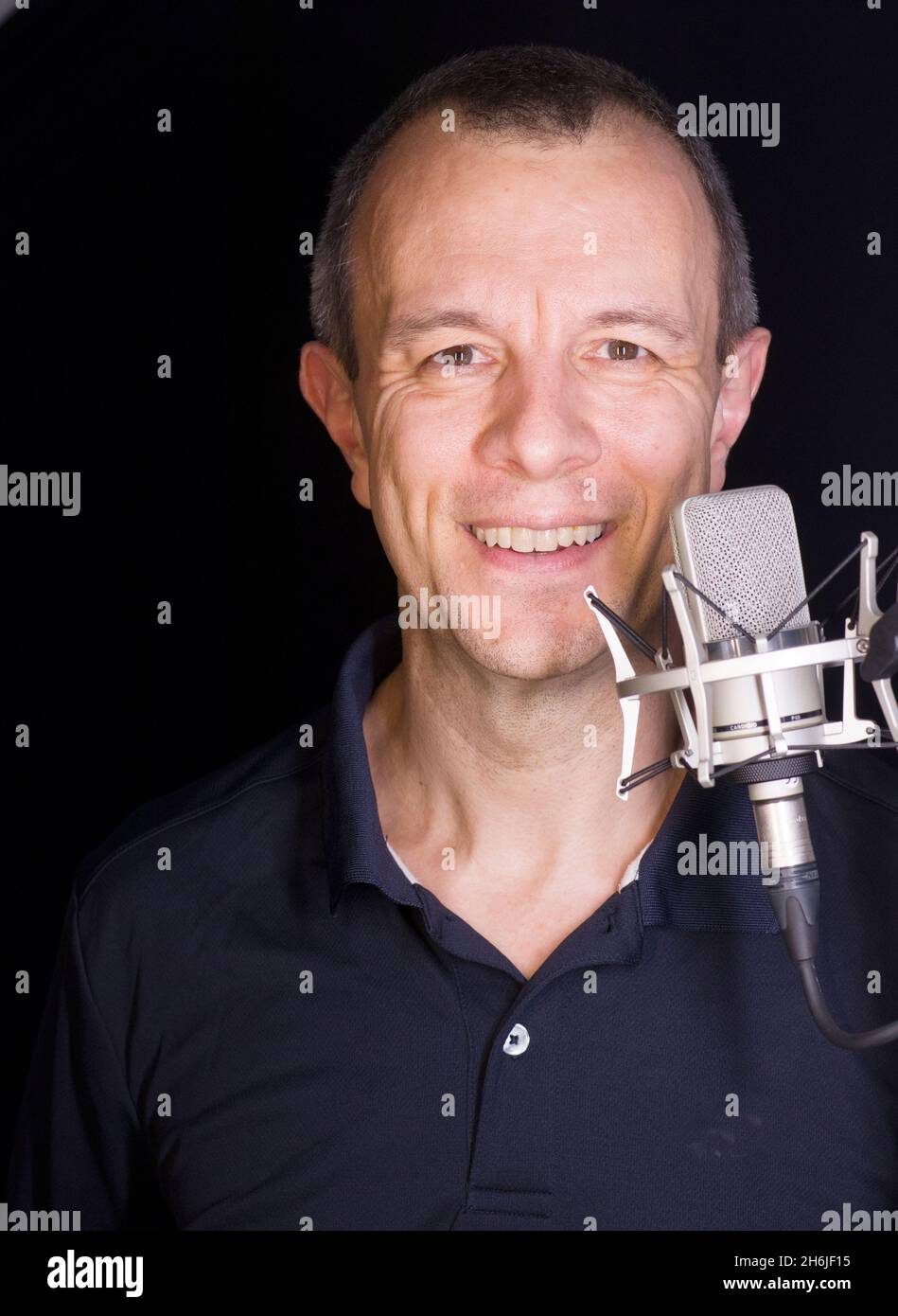 Voiceover artist voice actor in vocal recording studio with larg ...