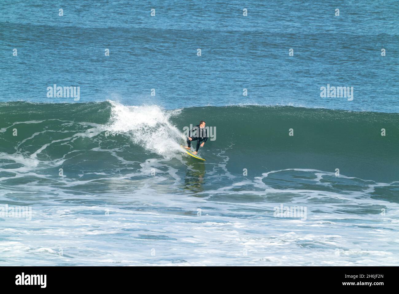 A surfer demonstrates his skill on a sizeable wave at Putsborough ...