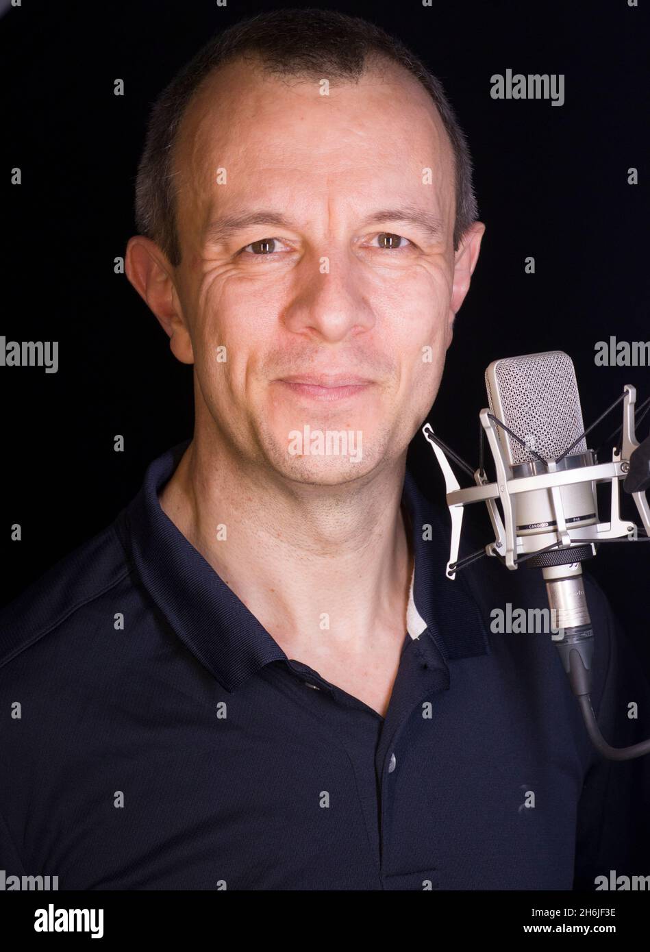 Voiceover artist voice actor in vocal recording studio with larg ...