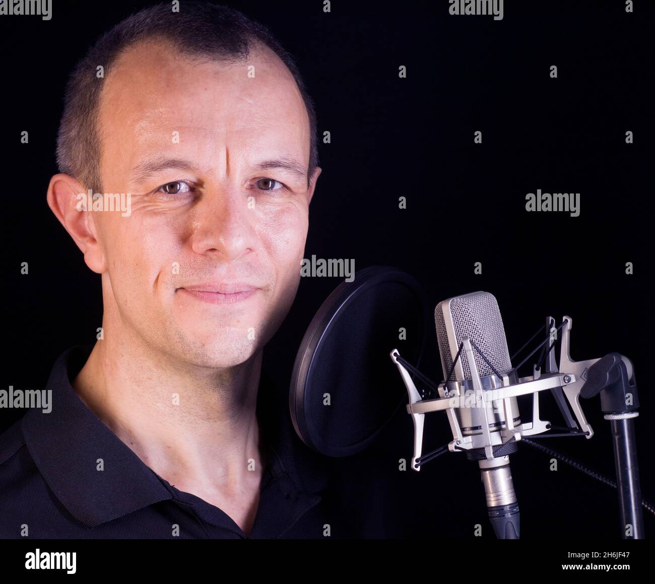 Voiceover artist voice actor in vocal recording studio with larg ...