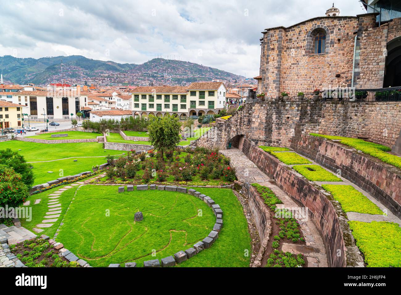 View of Coricancha with garden and cityscape of Cusco, Peru. Coricancha ...