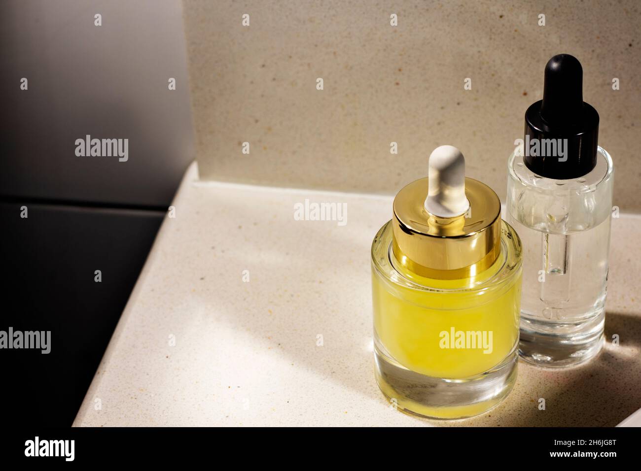 glass containers with cosmetic skin care products on the top of the ...