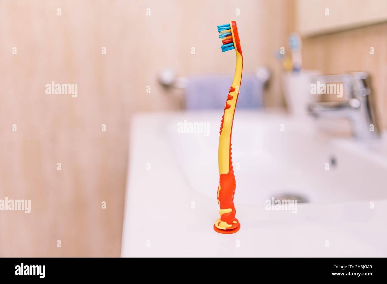 Detail of children's toothbrush on the sink, in the bathroom, with the ...