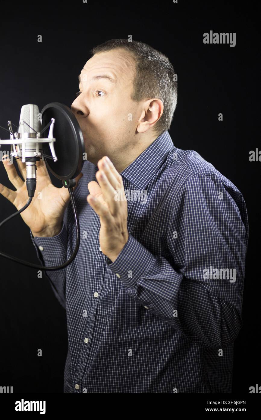Voiceover artist voice actor in vocal recording studio with larg ...