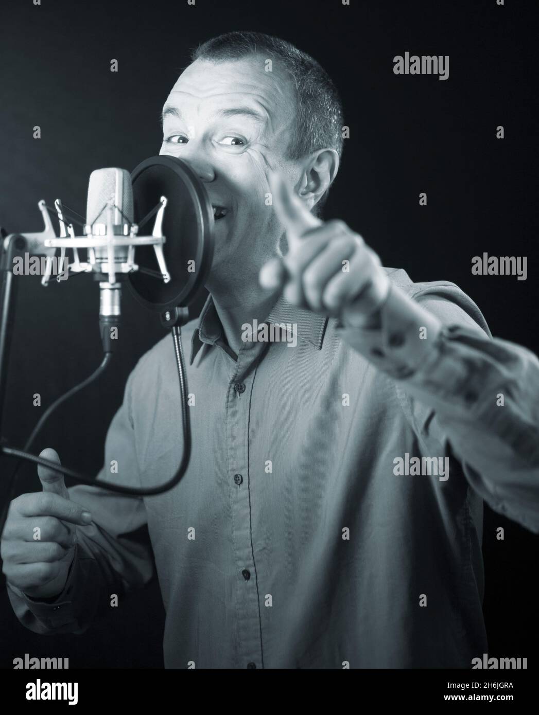 Voiceover artist voice actor in vocal recording studio with larg ...