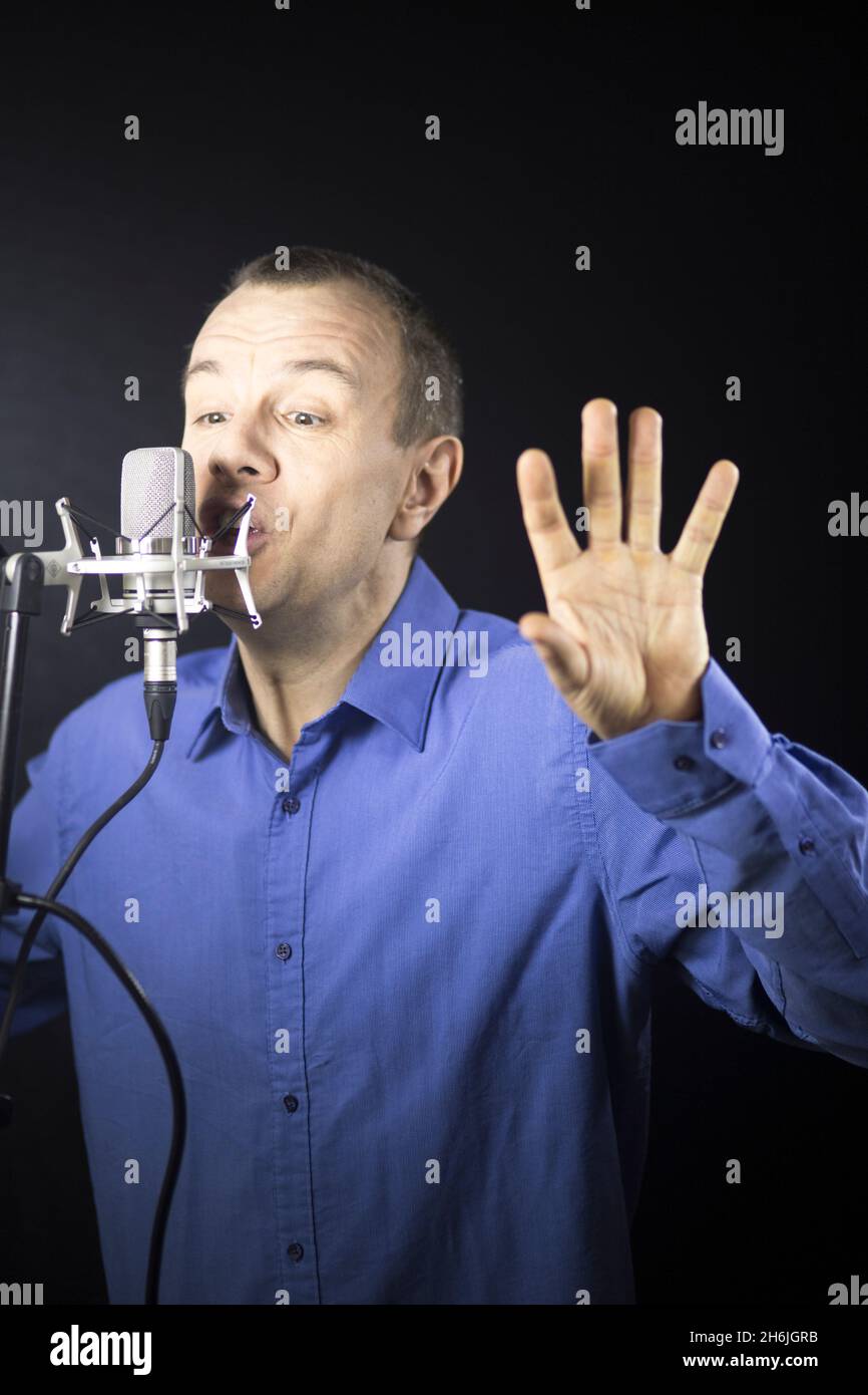 Voiceover artist voice actor in vocal recording studio with larg ...