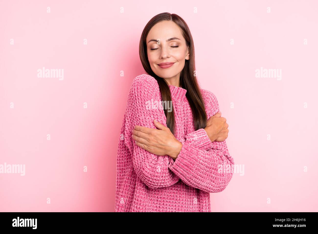 Photo of sweet young lady hug herself wear pink pullover isolated on ...