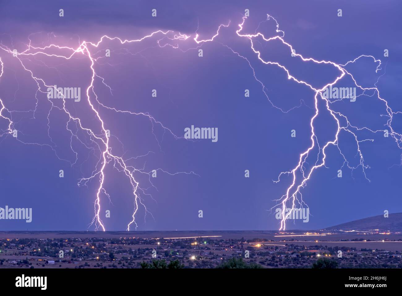 Lightning bolts striking Prescott area in the distance with the town of ...