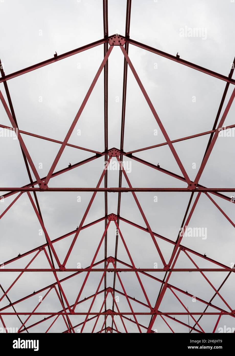 Vertical shot Red steel structure skeleton with cloudy sky in the ...