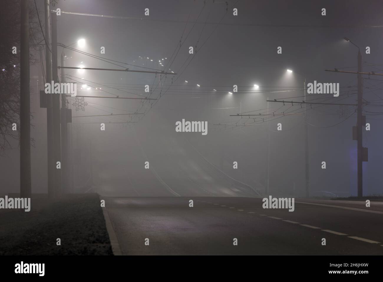 empty foggy night road with rows of lamp posts Stock Photo - Alamy