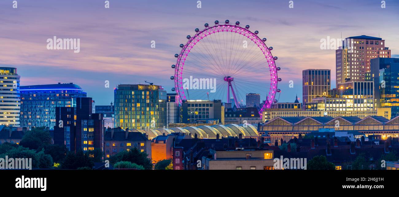 View of the London Eye and rooftop of Waterloo Station at dusk ...