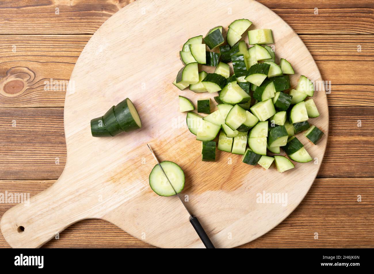 cutting fresh cucumber on a chop board Stock Photo - Alamy