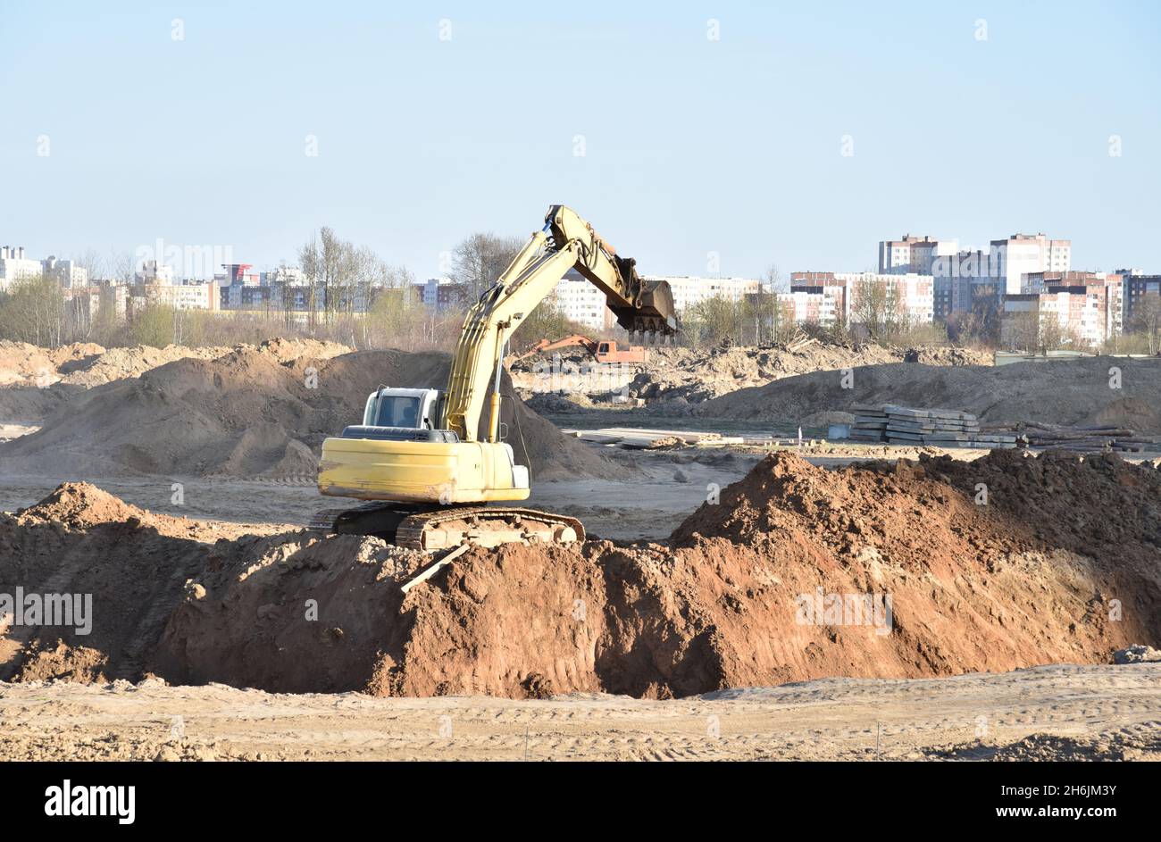 Excavator dig trench at construction site. Digging the pit foundation ...