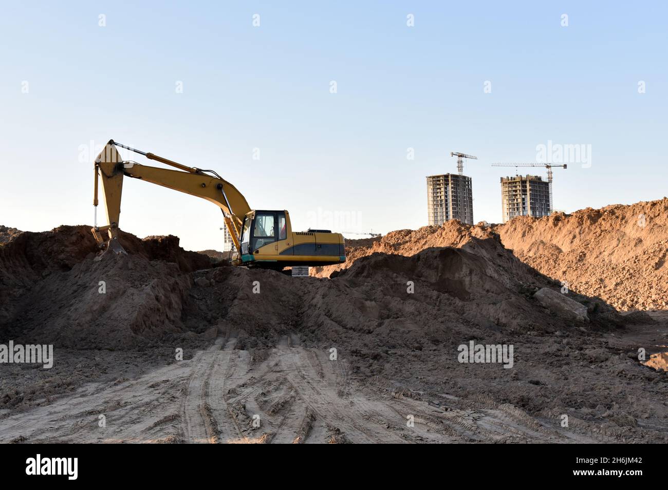 Excavator dig trench at construction site. Digging the pit foundation ...