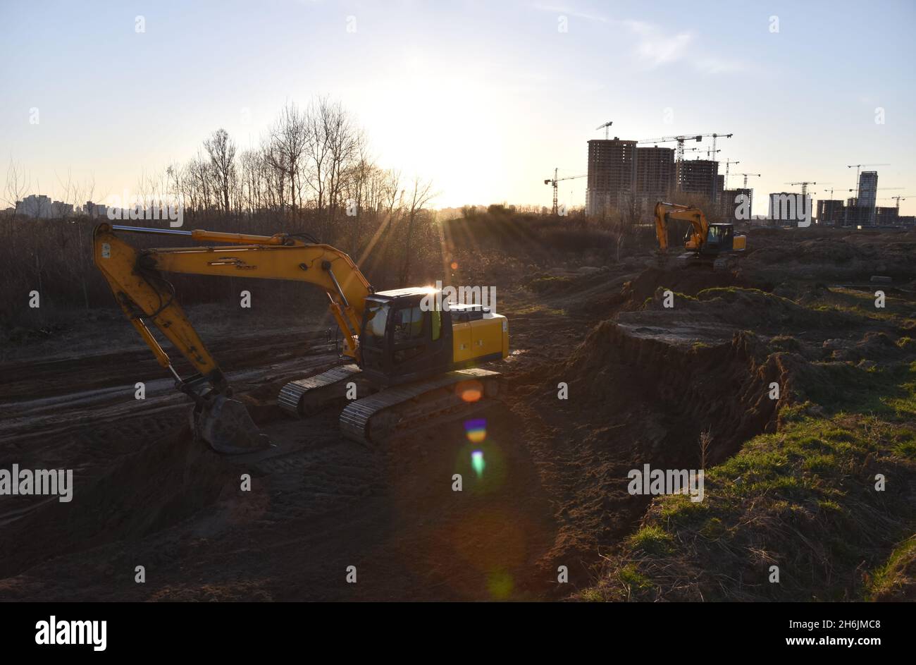 Excavator dig trench at construction site. Digging the pit foundation ...
