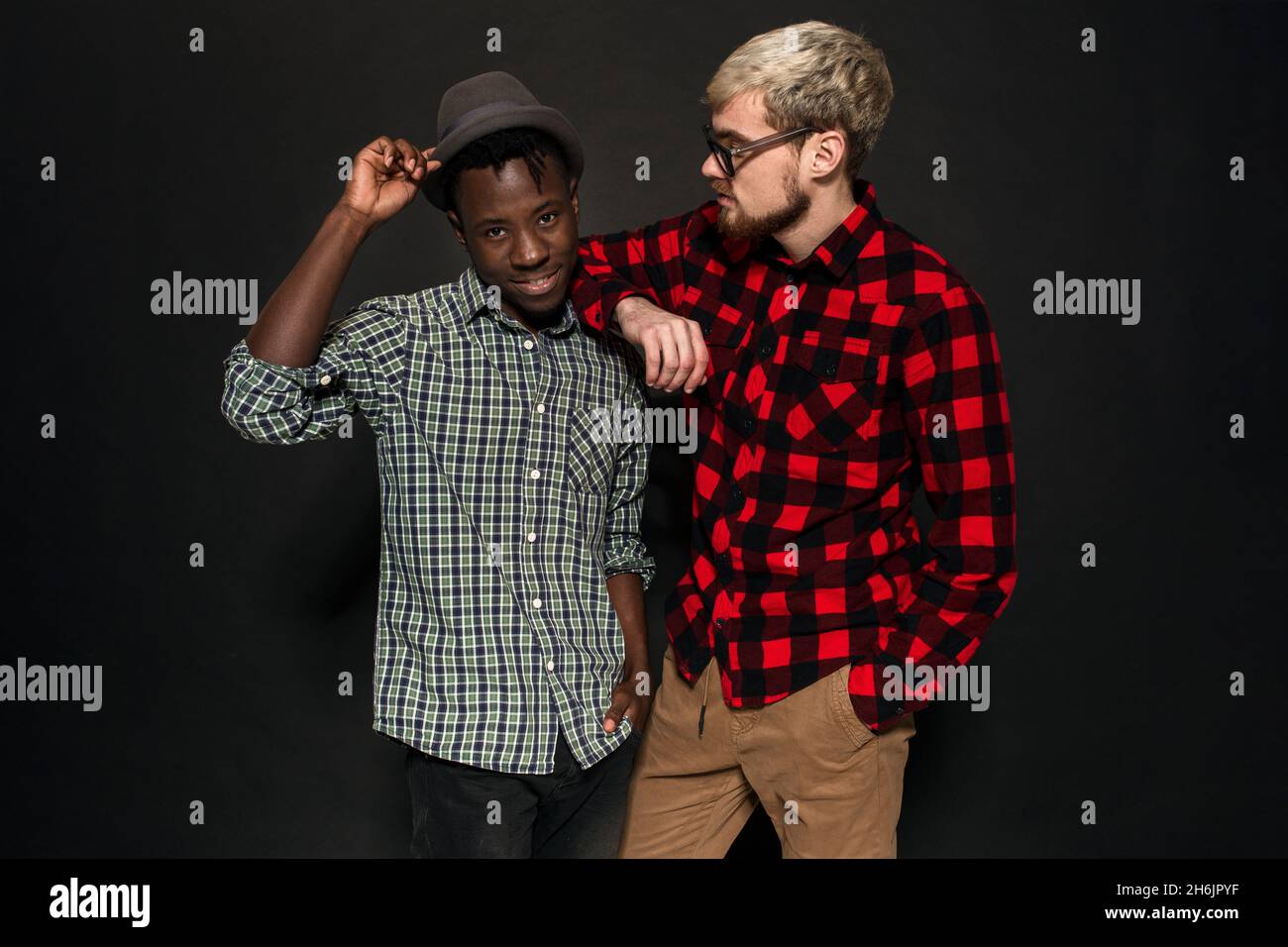 Studio lifestyle portrait of two best friends hipster boys going crazy ...