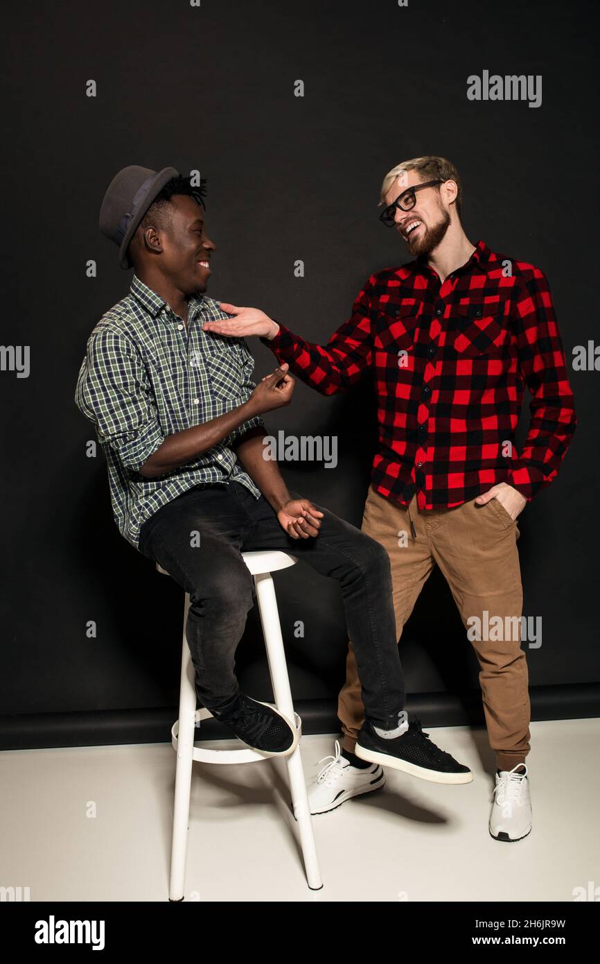 Studio lifestyle portrait of two best friends hipster boys going crazy ...
