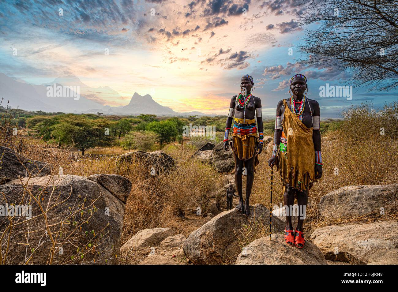 Traditional dressed young girls from the Laarim tribe standing on a ...