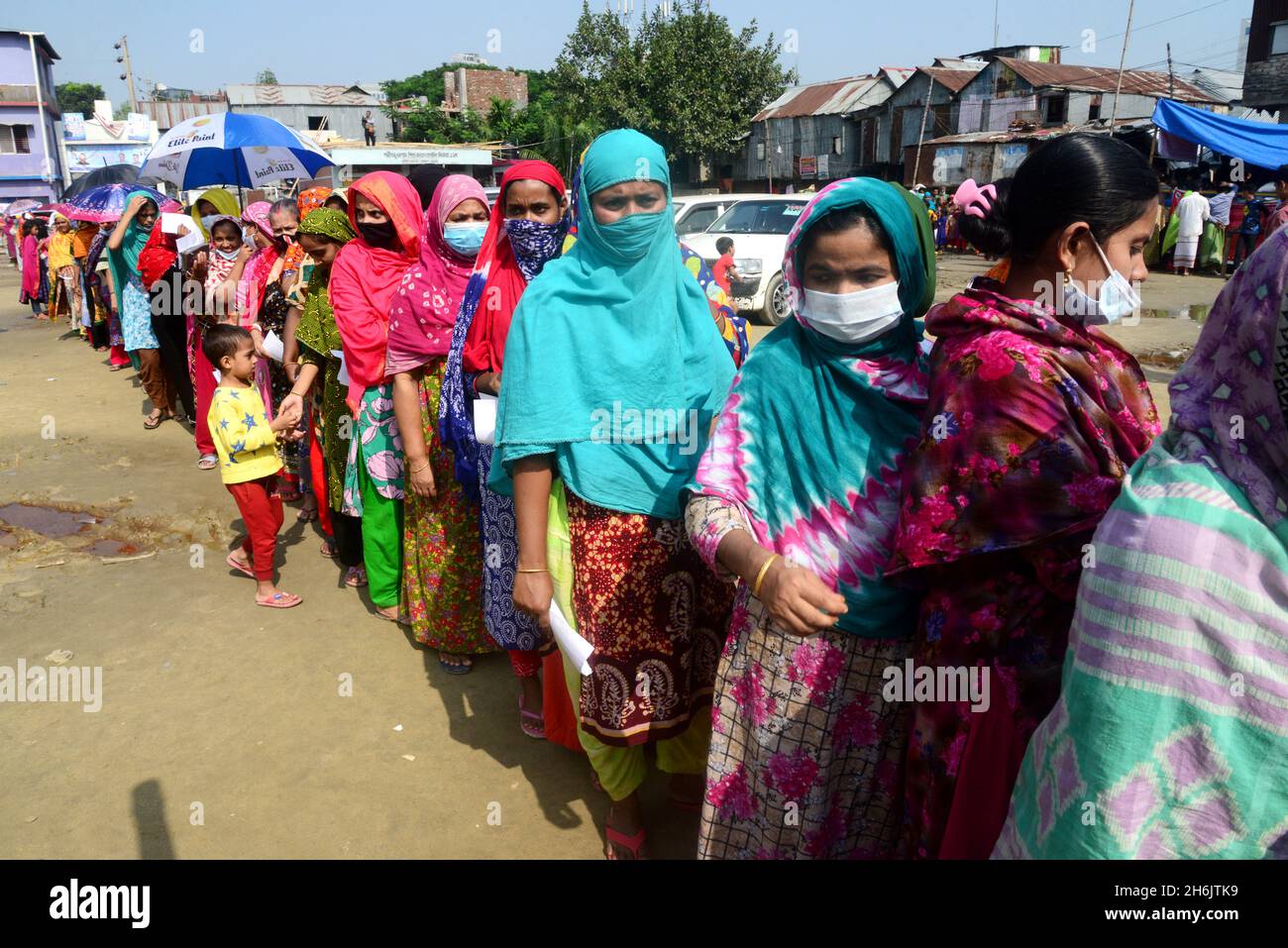 Slum women waits in a line for receive a dose of the AstraZeneca/Oxford ...