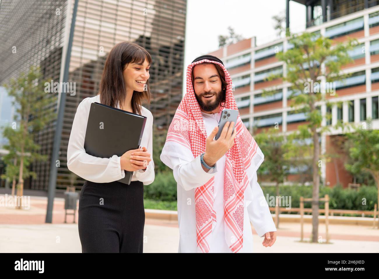 Smiling saudi arabia businessman wearing traditional clothes and young ...
