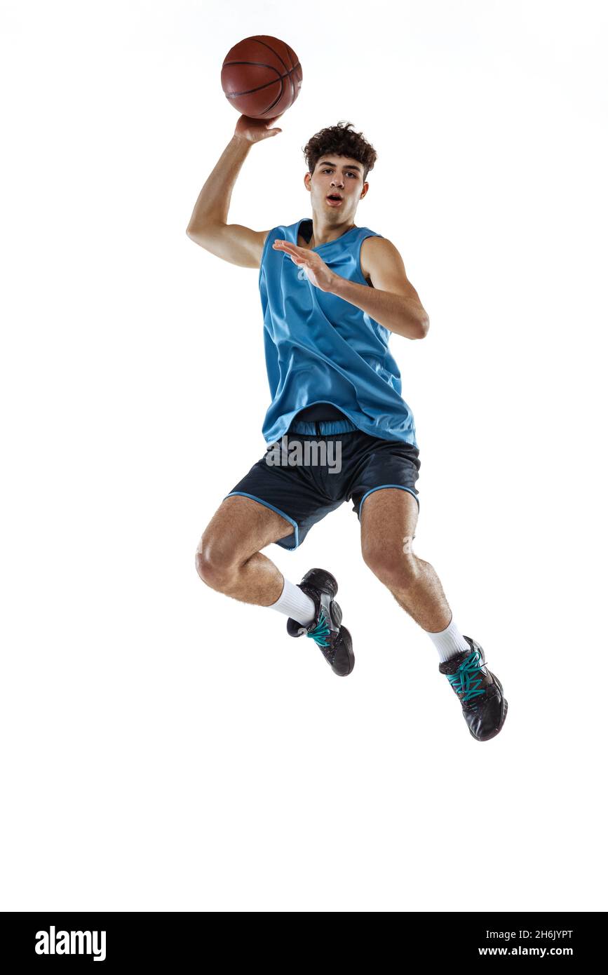 Full length portrait of basketball player training isolated on white ...