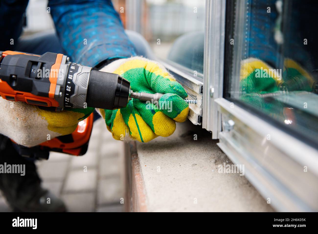 The wizard is engaged in installing windows. Repair work Stock Photo ...