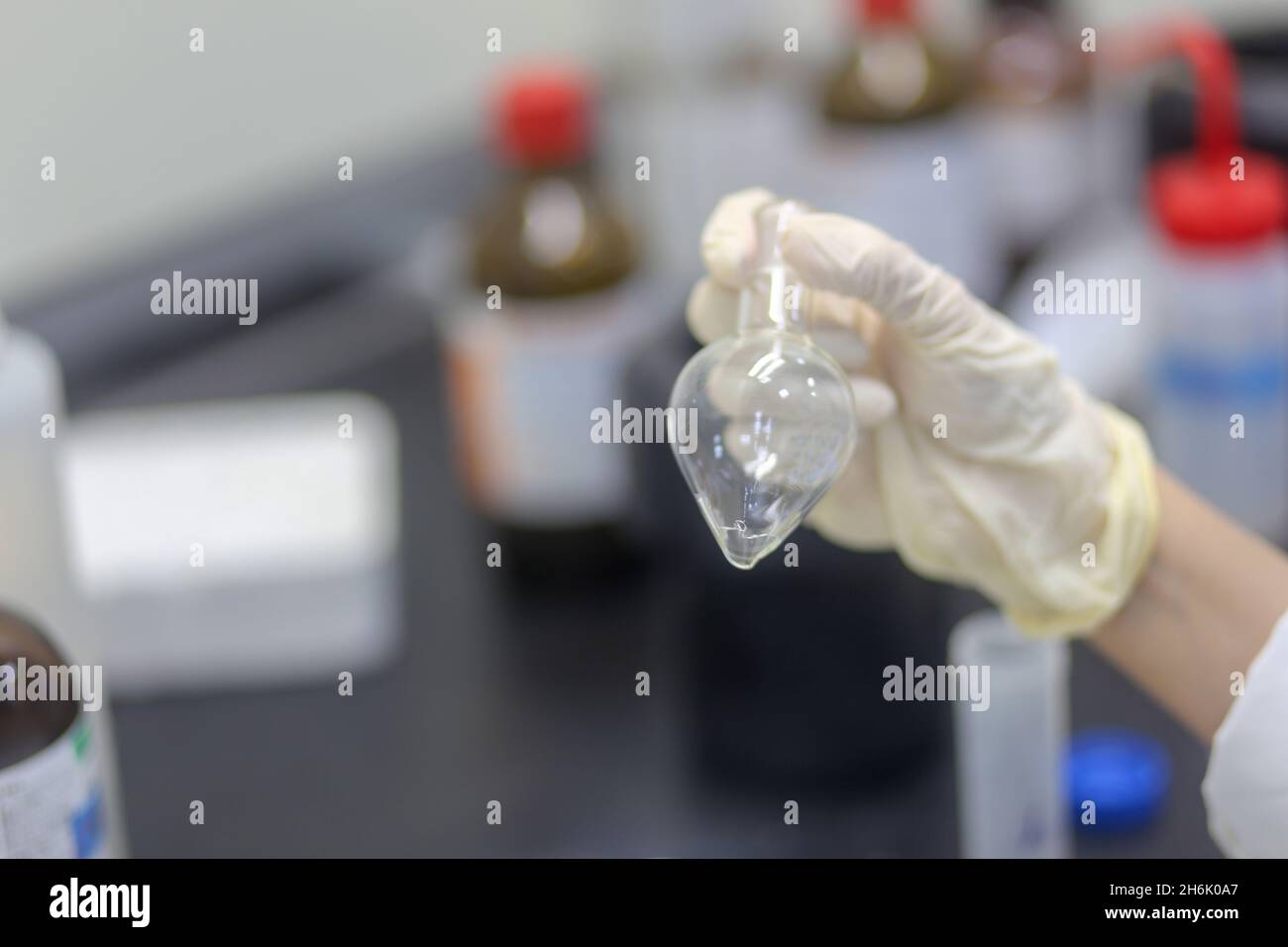 Closeup of a glass flask broken in the hand of a scientist in the ...