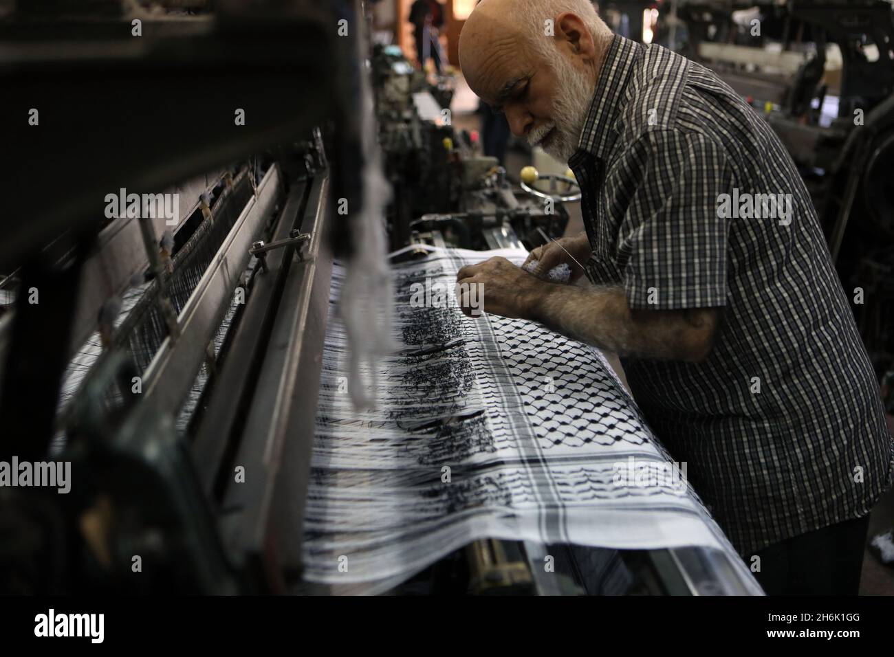 Hebron. 16th Nov, 2021. An employee works at a Keffiyeh textile factory ...