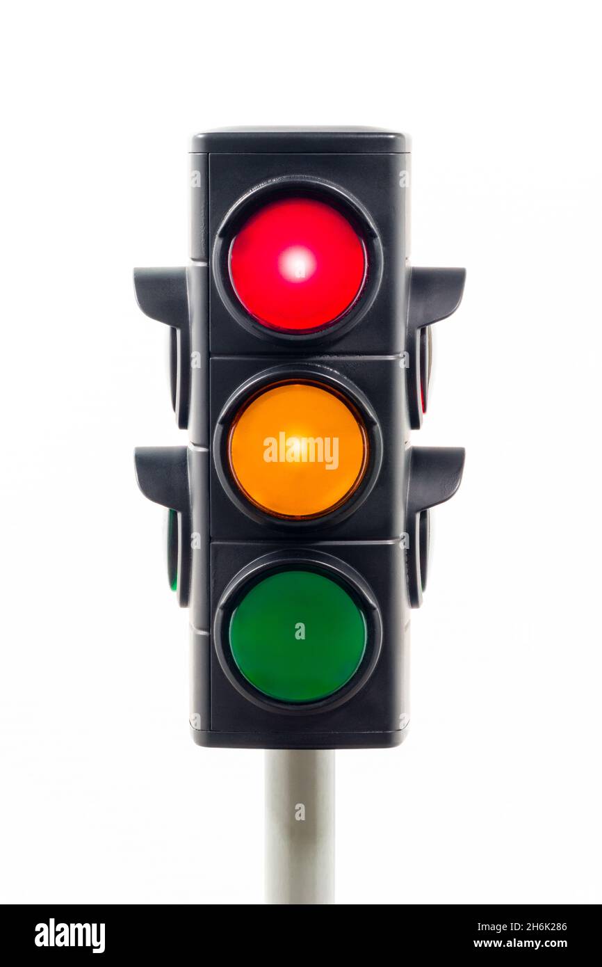 Illuminated traffic light isolated on a white background showing red ...