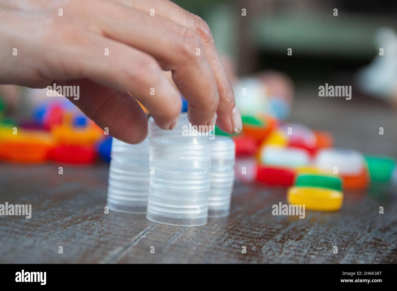 Hand holding recycled soda caps Stock Photo - Alamy