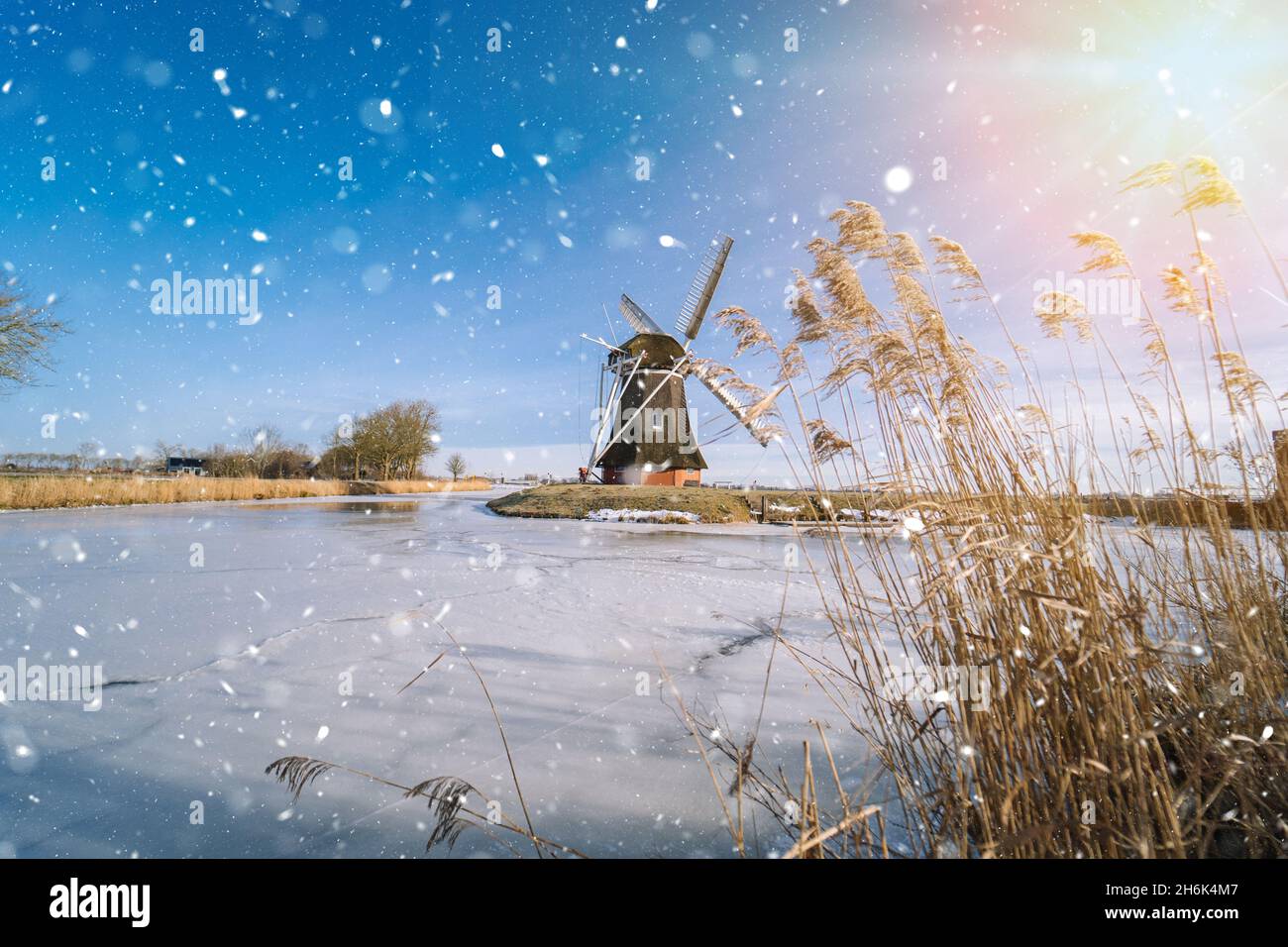 Typical winter dutch landscape with windmill. frozen canal in ...