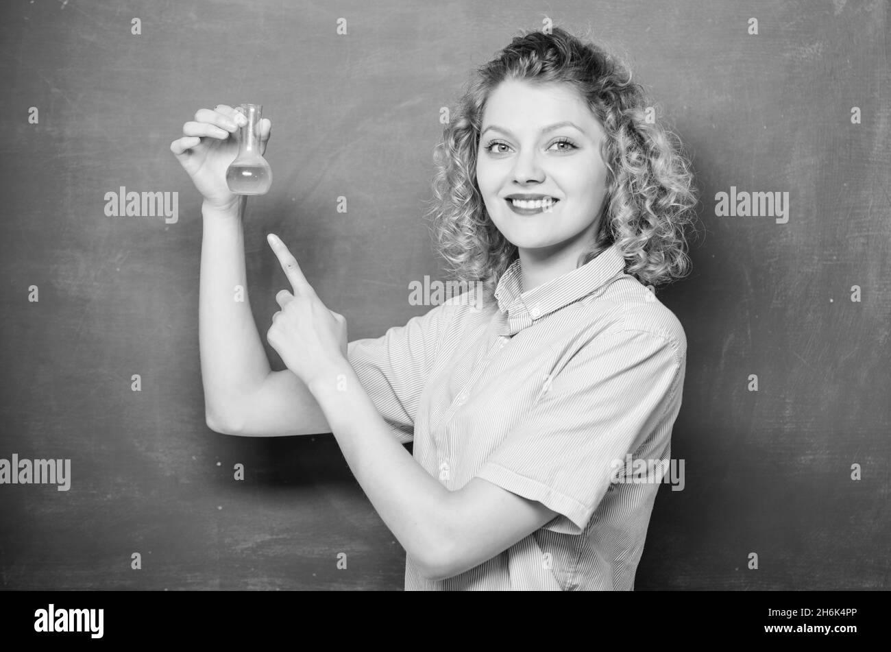 girl hold chemical flask with liquid. biology experiment. sample ...