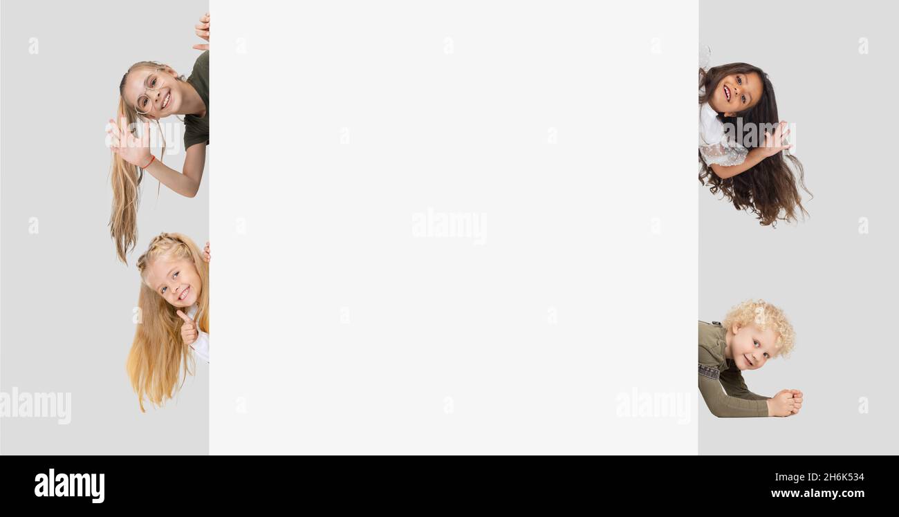 Collage of four beautiful children, kids, boys and girls waving and ...