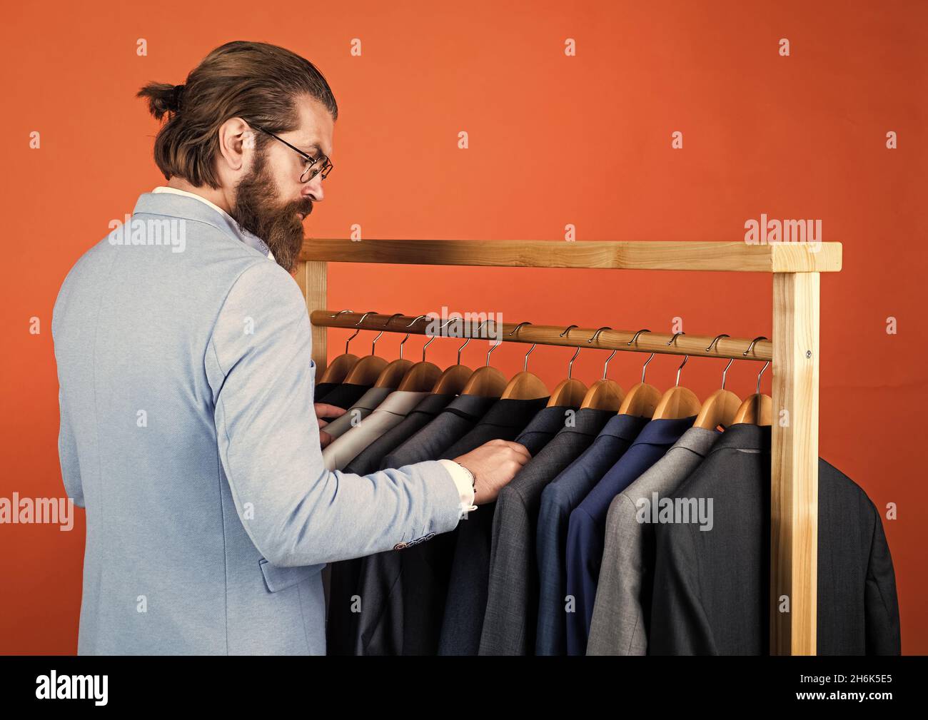 well groomed man in wedding formalwear has beard choose jacket in ...