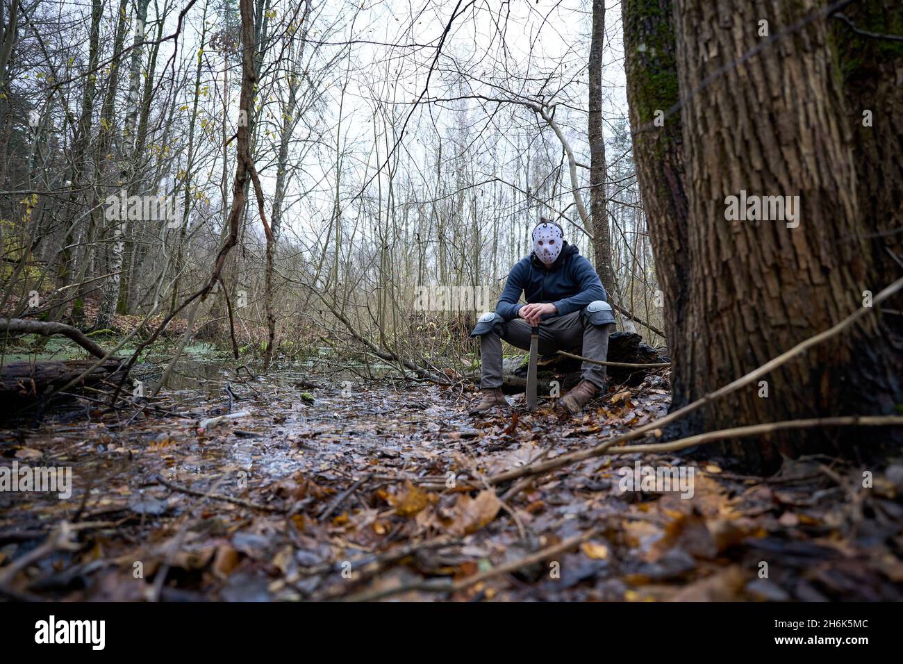 Serial killer Jason Voorhees in hockey mask and machete sitting on the ...