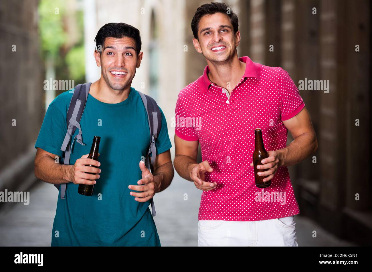 Male fans walking with beer Stock Photo - Alamy