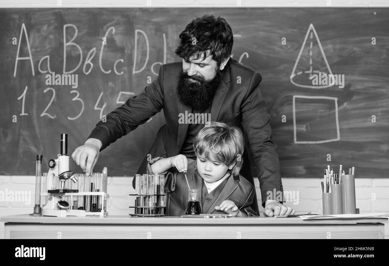 student doing science experiments with microscope in lab. father and ...