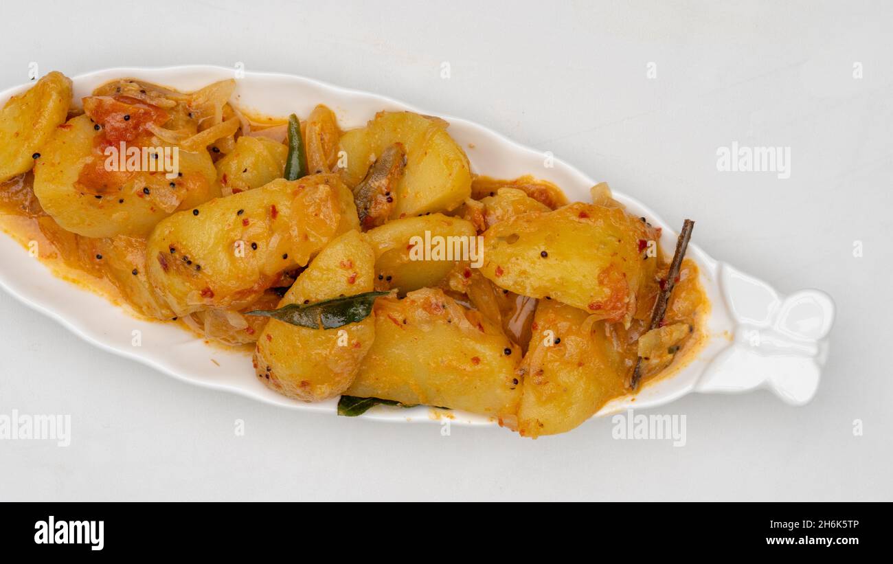 Sri Lankan spicy dry potato curry(devilled potatoes) isolated on white ...