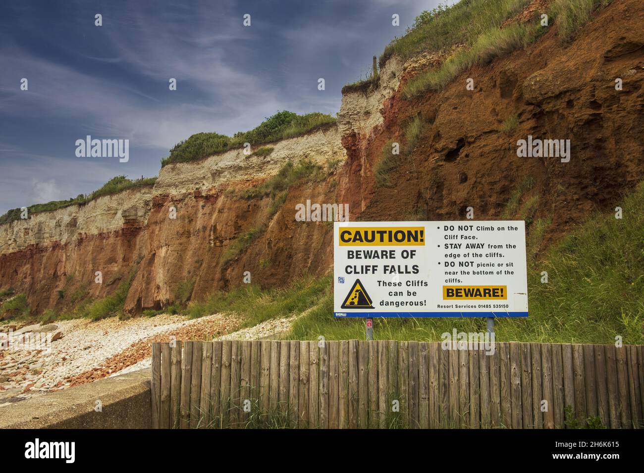 Warning sign about dangerous cliffs, beware cliff falls Stock Photo - Alamy