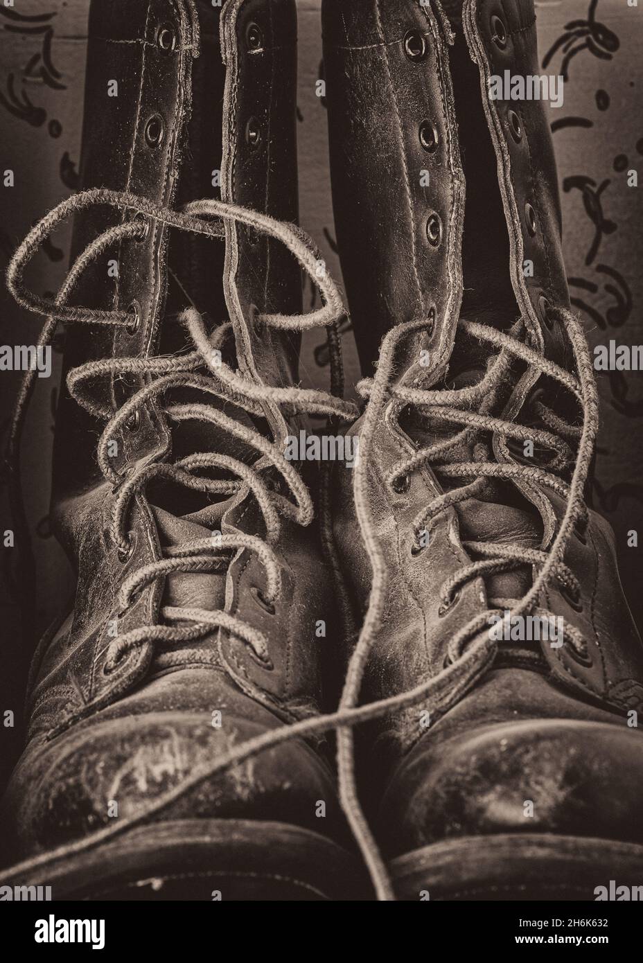 Old weathered untied high top leather boots on a shelf Stock Photo - Alamy