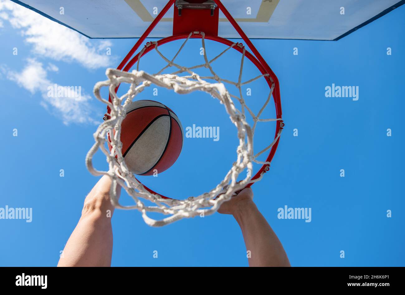 basketball ball flying through basket in players hands, winning Stock ...