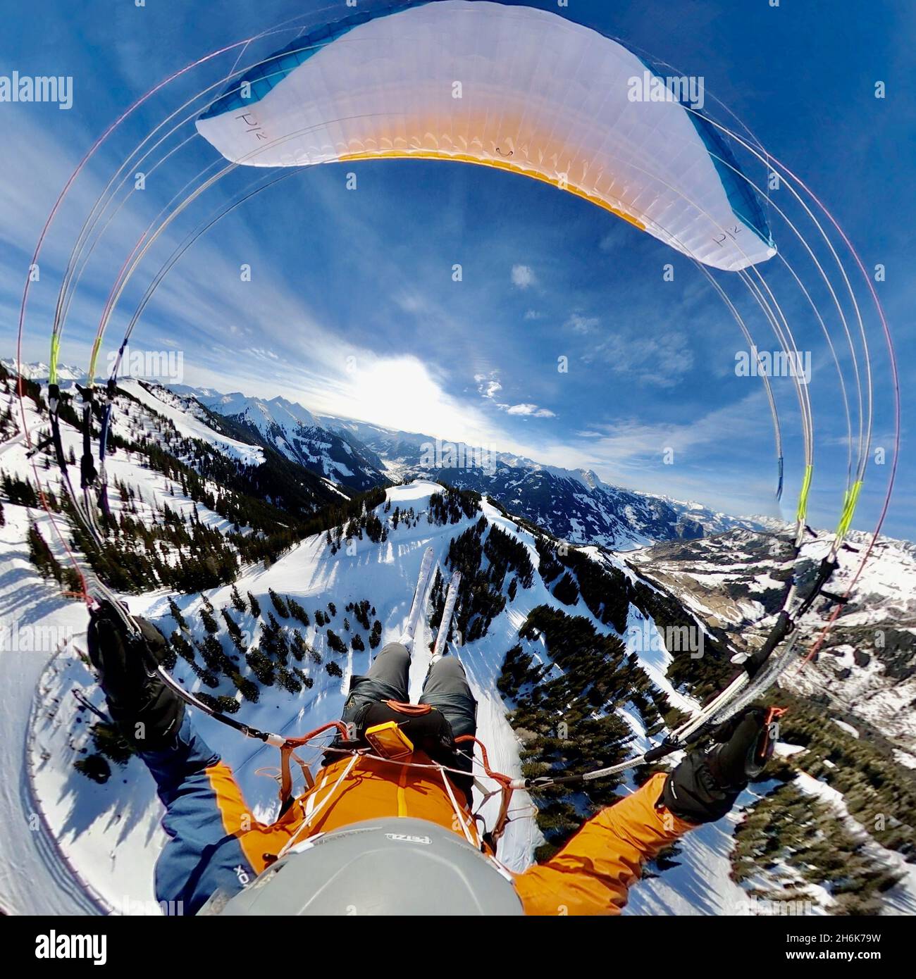 Fish eye of a paraglider flying over snowy mountains Stock Photo - Alamy