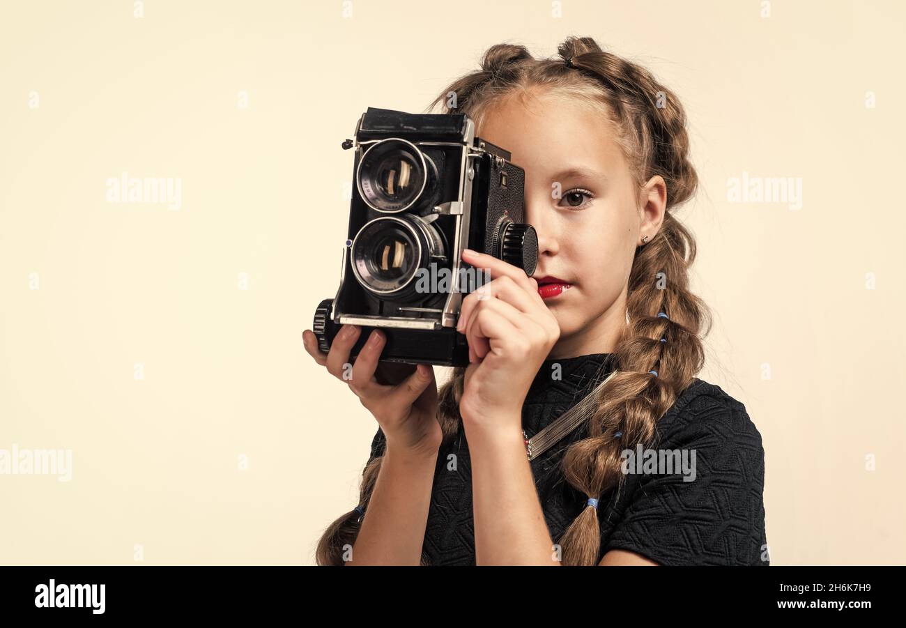 take shot. retro camera. happy childhood. kid has elegant look ...