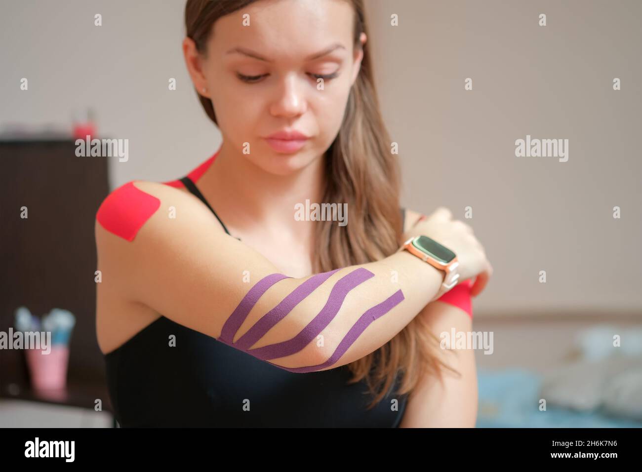 Close-up female elbow with applied kinesiology tape Stock Photo - Alamy